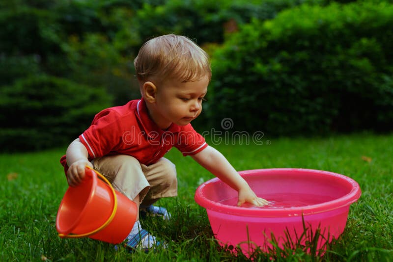 Child Playing with Water in the Garden Stock Image - Image of caucasian ...