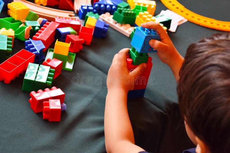 A Child Plays with Colored Cubes. Children`s Plastic Multi-colored ...