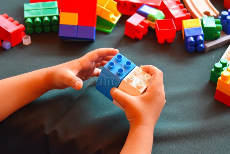 A Child Plays with Colored Cubes. Children`s Plastic Multi-colored ...
