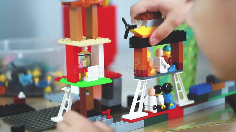 Child Plays with Constructor. Little Boy Builds Figures from Cubes of ...