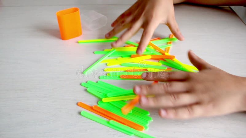 A Child Plays with Counting Material of Different Colors while Sitting ...
