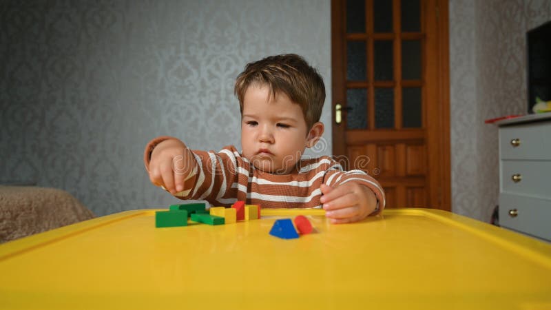The Child Plays Geometric Shapes. Child Development Stock Image - Image ...
