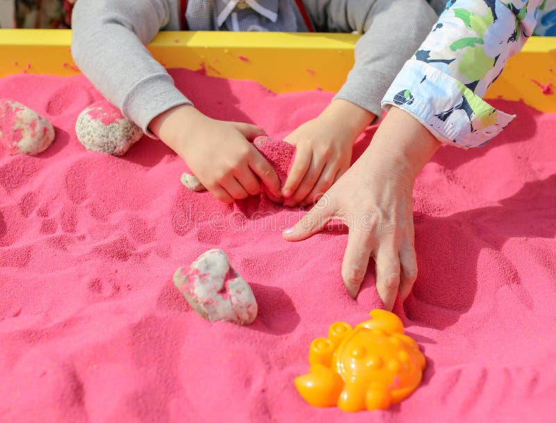 The Child Plays with His Hands in the Pink Sand Stock Photo - Image of ...