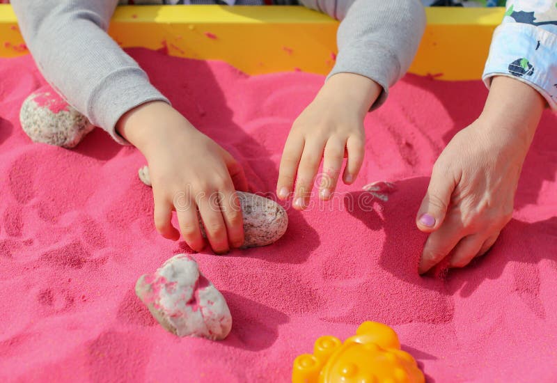The Child Plays with His Hands in the Pink Sand Stock Photo - Image of ...