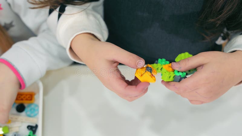 A Child Plays with a Lego Constructor. Close-up of a Girl S Hands ...