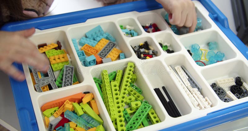 A Child Plays with a Lego Constructor. Close-up of a Girl S Hands ...