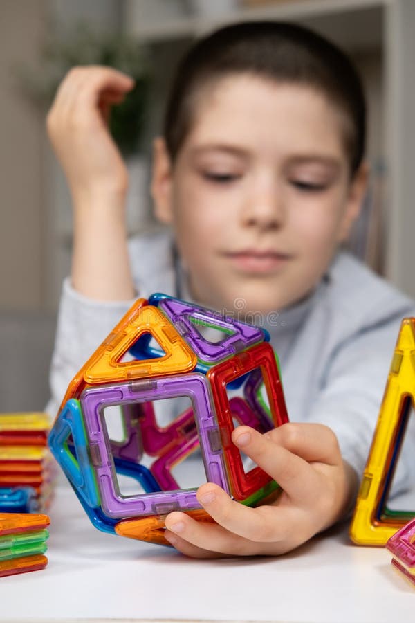 A Child Plays with a Magnetic Construction Set. Interesting Educational ...