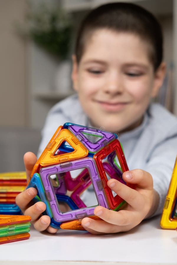 A Child Plays with a Magnetic Construction Set. Interesting Educational ...