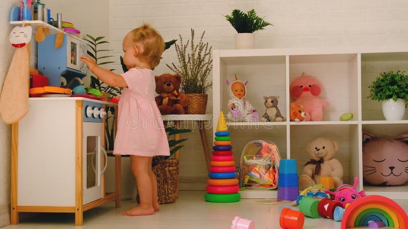 A Child Plays in a Room with Toys. Selective Focus Stock Footage ...