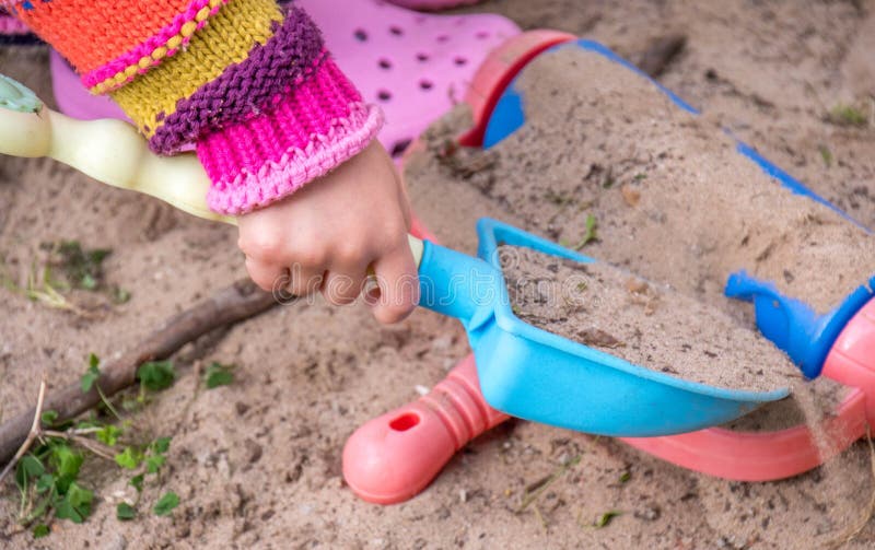 Child playing in the sand stock photo. Image of resource - 197753364