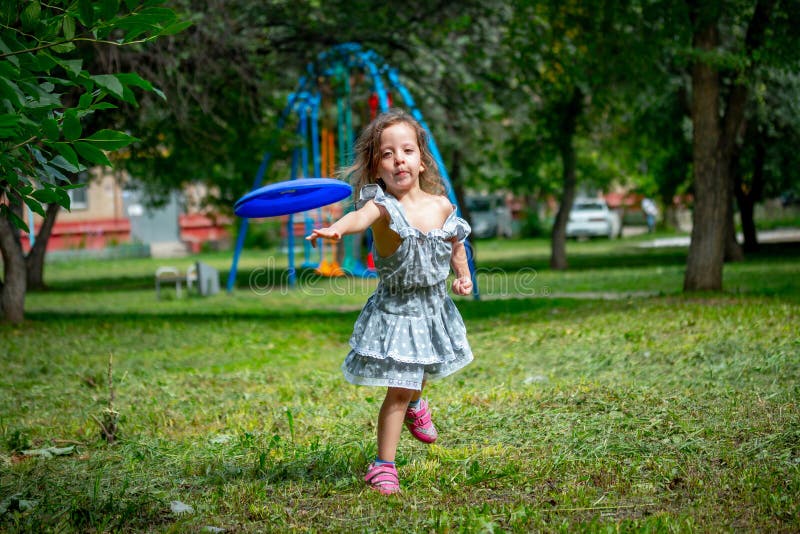Child Plays Tossing a Flying Disc Stock Photo - Image of small, happy ...