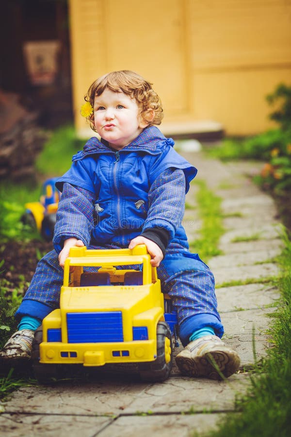 A Child Plays a Toy Car on the Park. Stock Photo - Image of human ...