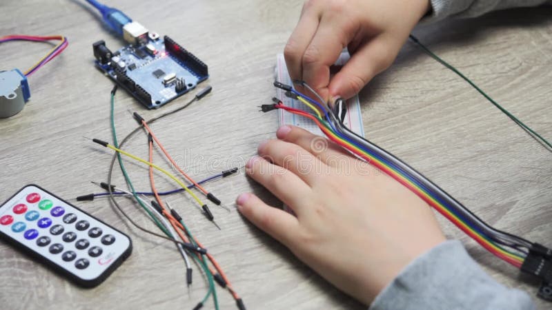 A Child Plugging Cables To Sensor Chips while Learning Arduino Coding and Robotics Stock Video ...