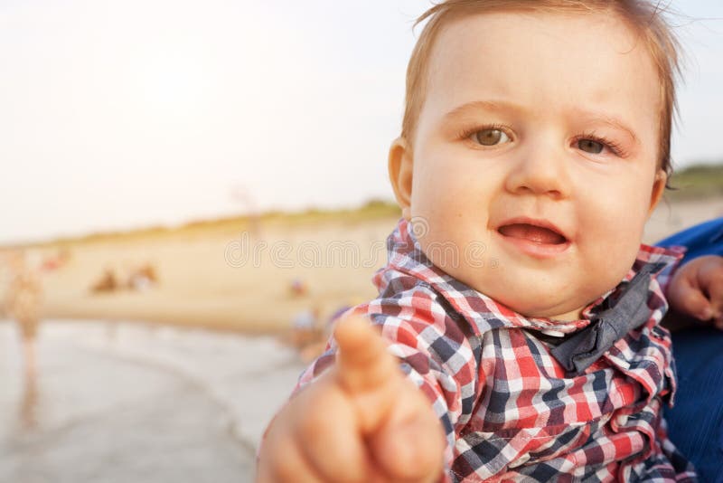 Child Pointing at the Camera with Funny Expression on the Beach Stock ...