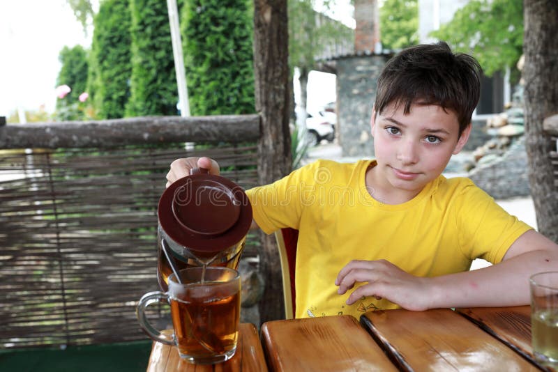 Child Pouring Tea into Glass Stock Photo - Image of kettle, hand: 255554584