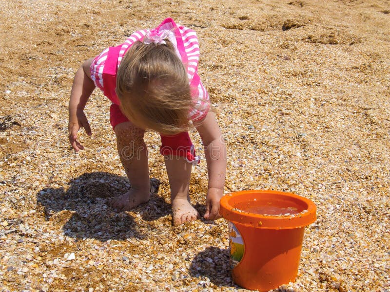 Child Pours Sand into the Bucket Stock Image - Image of beach, girl ...