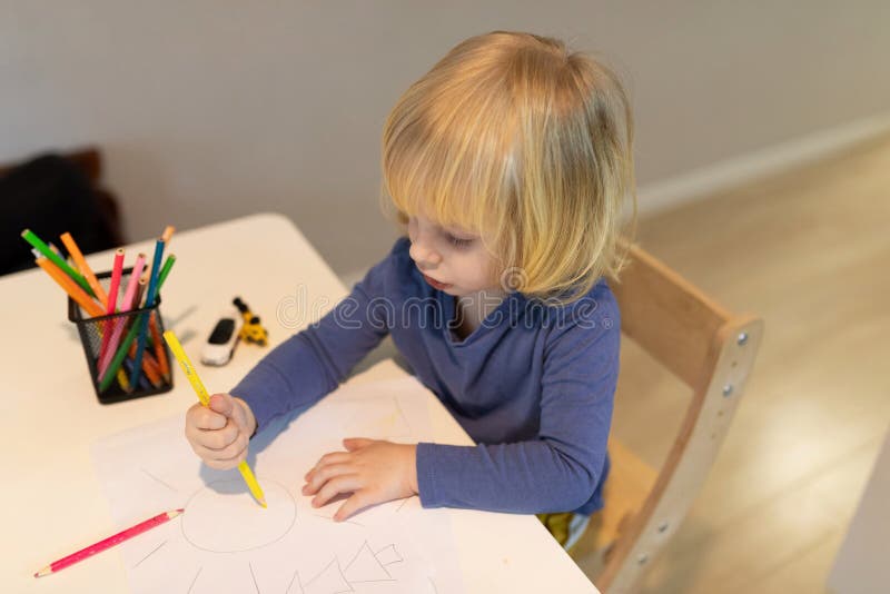 Child Practicing Drawing in a Cozy Indoor Space during Afternoon Hours ...