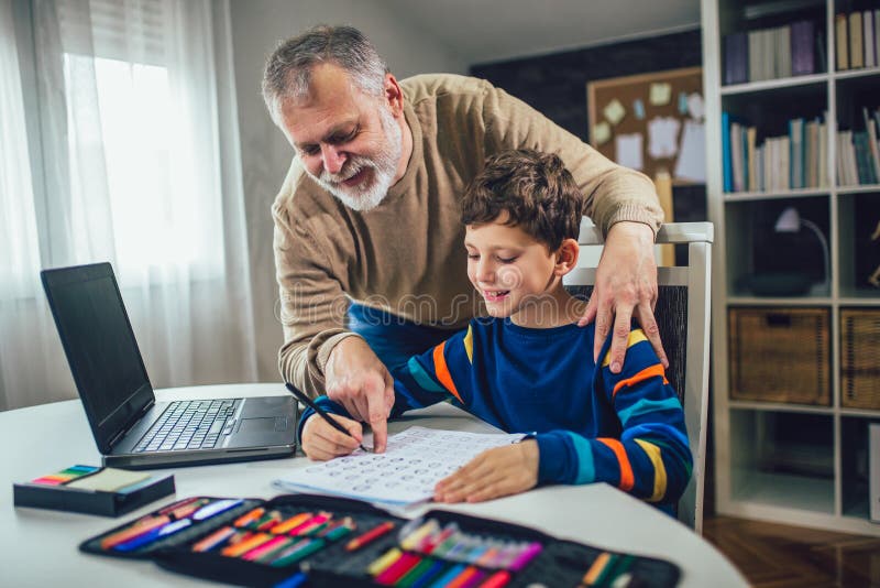 Boy Practicing Writing at Home with the Help of His Father Stock Photo ...