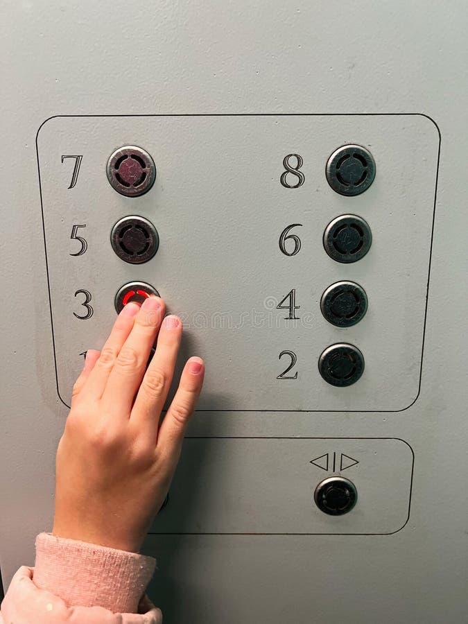 Child Pressing Elevator Button in a Modern Building Interior Stock ...