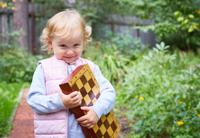 Child Prodigy Holds a Chessboard in His Hands. Stock Image - Image of ...