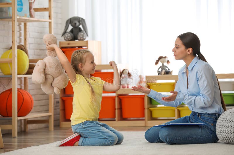 Child Psychotherapist Having Conversation with Little Girl Stock Photo ... Child Psychotherapist Having Conversation with Little Girl Stock Photo ...