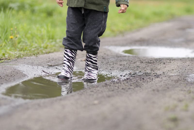 Child in a puddle stock image. Image of outdoor, jumping - 16974749
