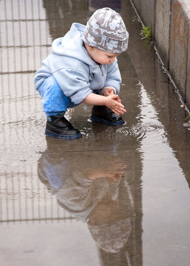 Child in a puddle stock photo. Image of flooding, playground - 22717046