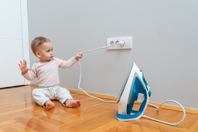The Child Pulls the Electrical Plug Out of the Socket and Turns Off the ...