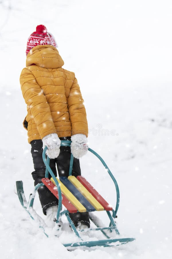 A child pulls a metal sled stock photo. Image of people - 204904760