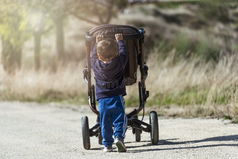 Child Pushing Pram in Nature Walk Stock Photo - Image of pushing, buggy ...
