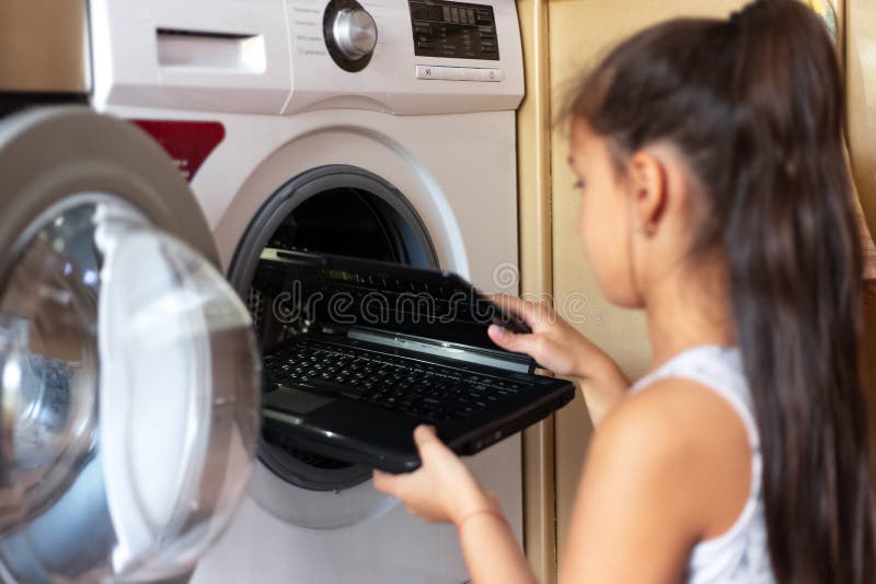 Child Girl Put Laptop in Washing Machine. Stock Image - Image of laptop ...