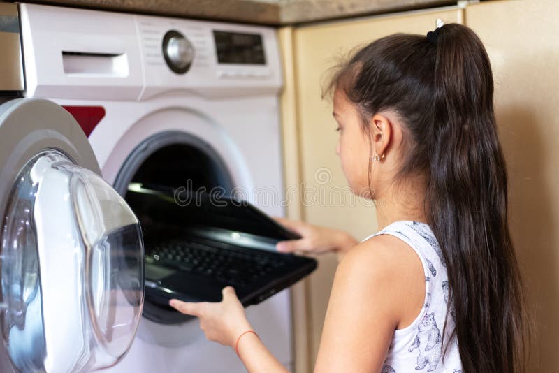 A Child Put a Laptop in Washing Machine. Stock Image - Image of ...