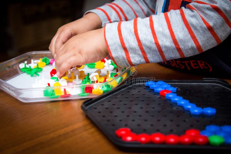 The Child Puts a Multicolored Mosaic Stock Photo - Image of people ...