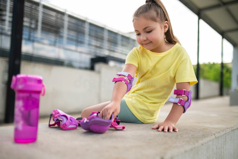 Child Putting on Safety Gear Getting Ready for Roller-blading Stock ...