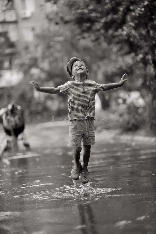 Child in the rain stock photo. Image of blur, happiness - 25684712