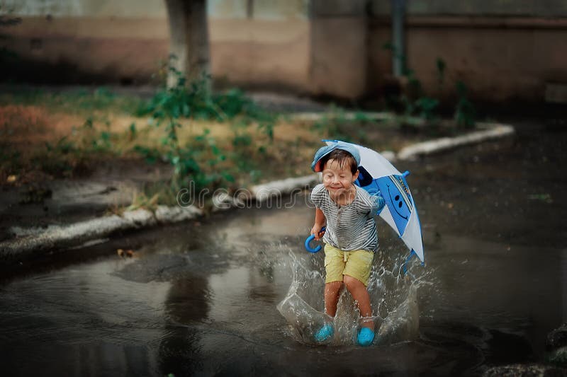 Child in the rain stock image. Image of white, open, entertainment ...