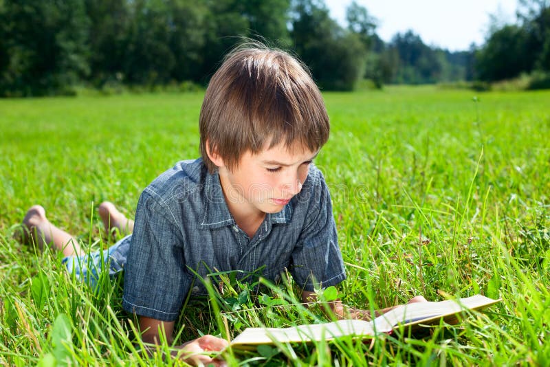 Child reading book outdoor stock photo. Image of education - 44869674