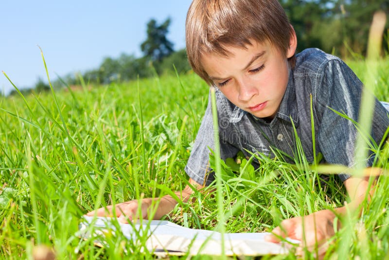 Child reading book outdoor stock image. Image of child - 46086017