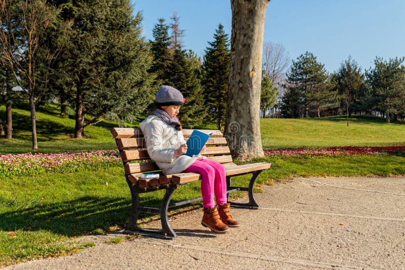 Child Reading the Book Outdoors in the Park Stock Image - Image of ...