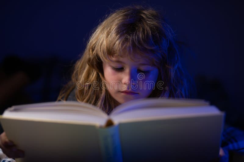 Child Reading a Magic Book in Bed. Kid Boy Read Books at Home ...