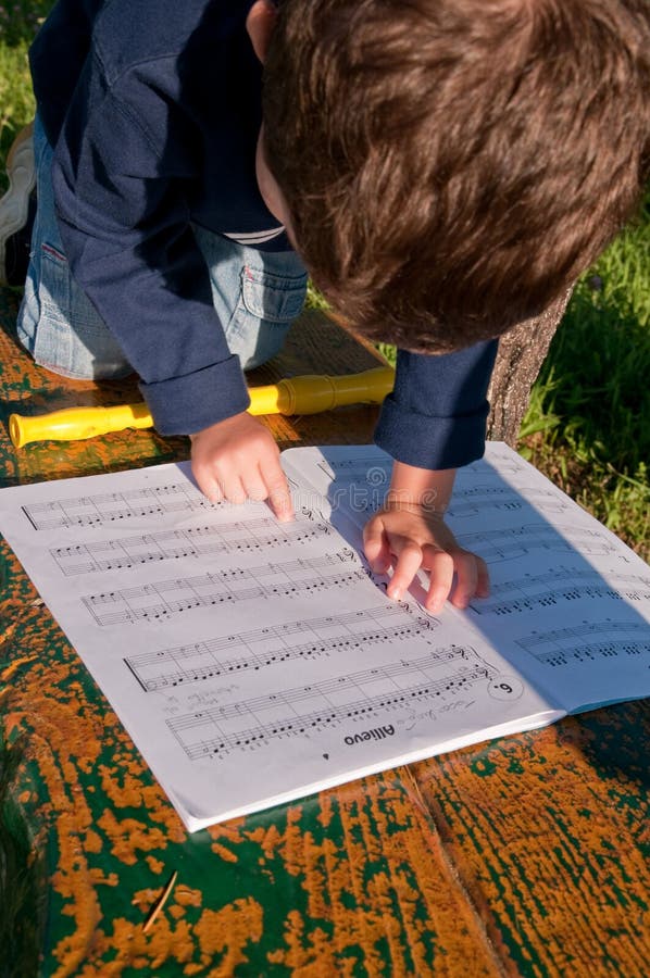 Child reading music stock photo. Image of education, flute - 49332260