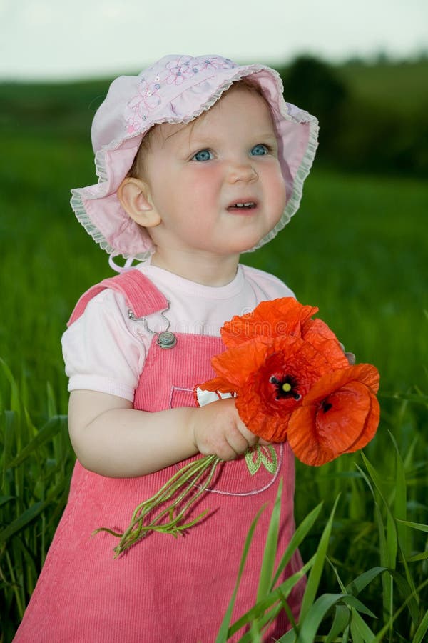Child with Red Flower Amongst Green Grass Stock Image - Image of lane ...