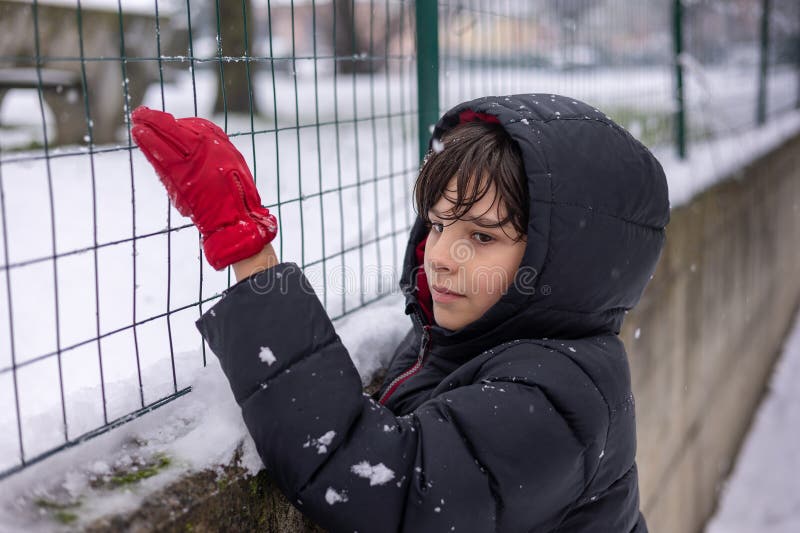 Child in Red Mittens Exploring Snowy Yard on Winter Day. World Snow Day ...