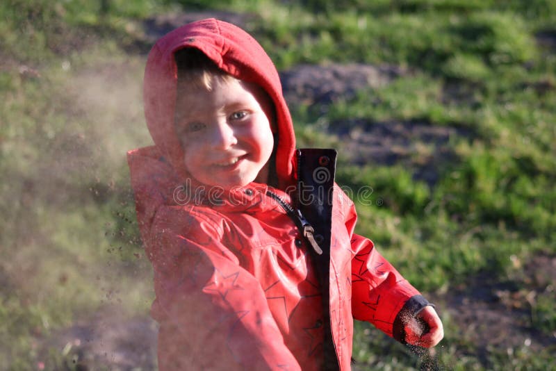 Child in red throwing sand stock image. Image of natural - 155761921