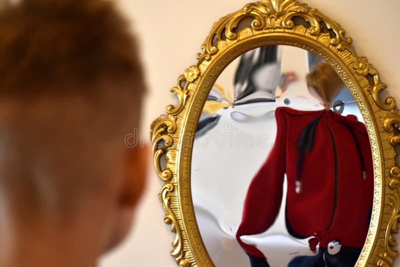 The Child Reflected in a Distorting Mirror. a Fun Reflection of the Boy ...