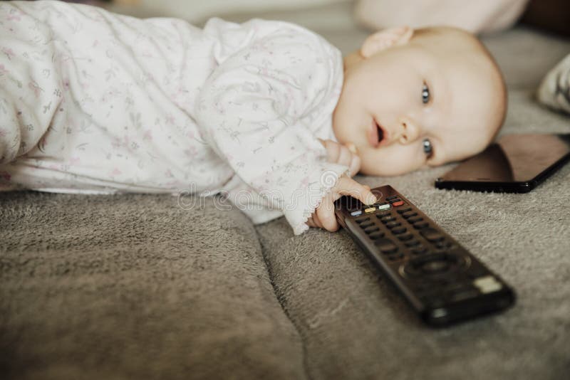 A Child with a Remote Control and a Telephone, Addiction To Technology ...