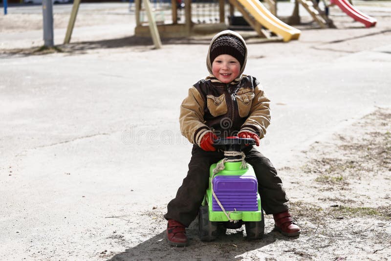 Child Rides a Toy Car in Spring Stock Photo - Image of baby, flower ...