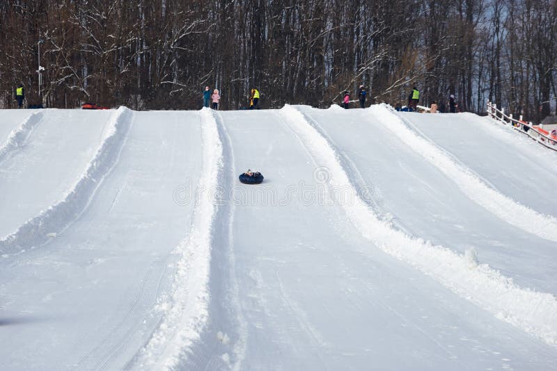 A Child Rides a Tube Off a Snow Slide Stock Photo - Image of leisure ...