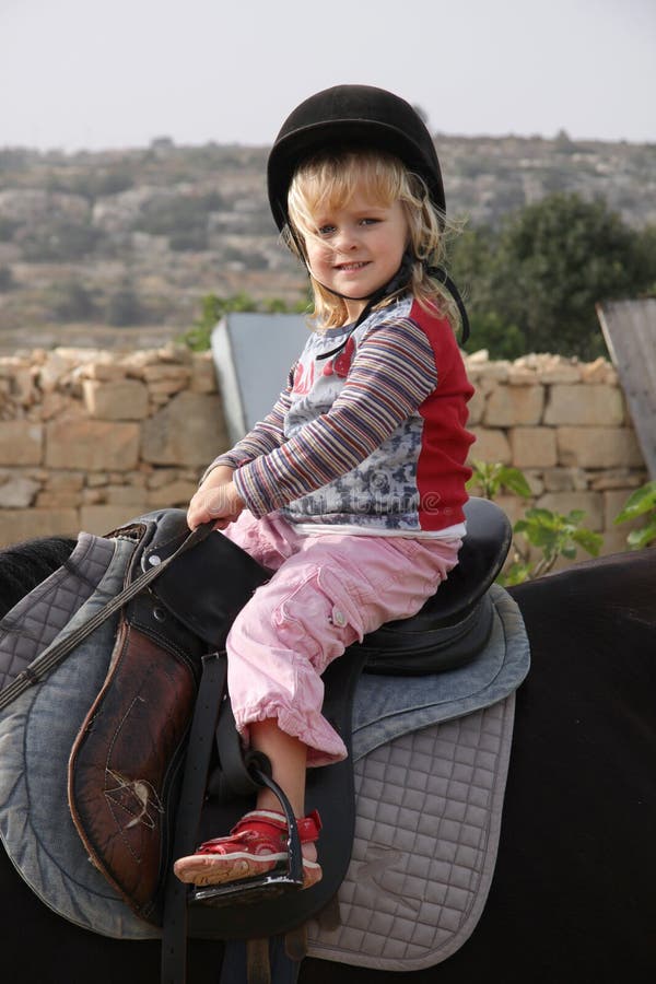 Child riding a horse stock image. Image of playing, animal - 13948233