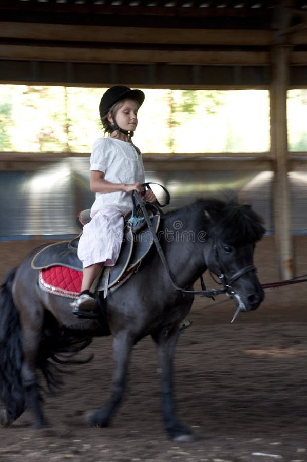 Child riding a pony stock image. Image of racehorse, activity - 25635795